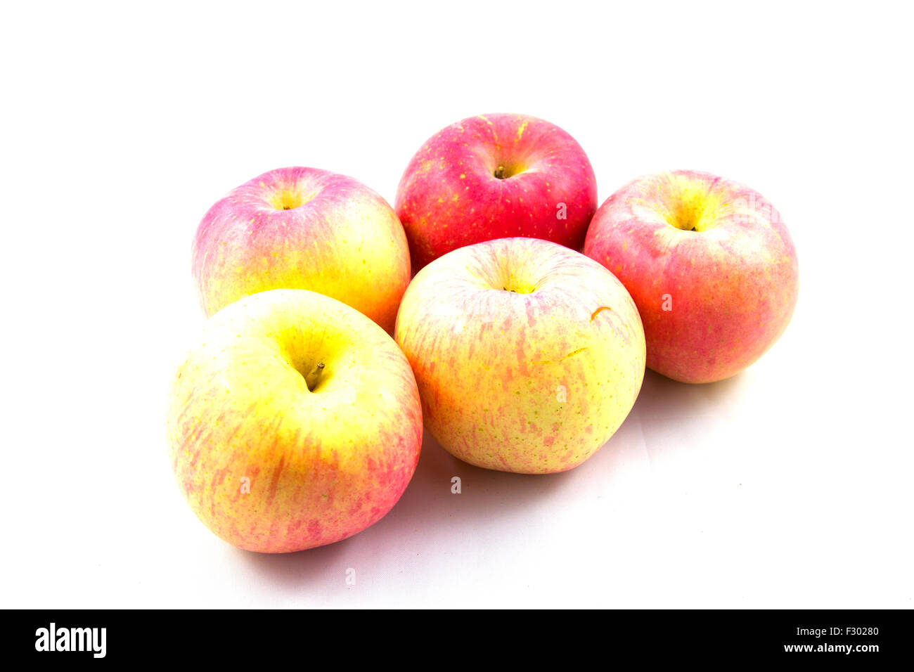 Five red apples on a white background Stock Photo - Alamy