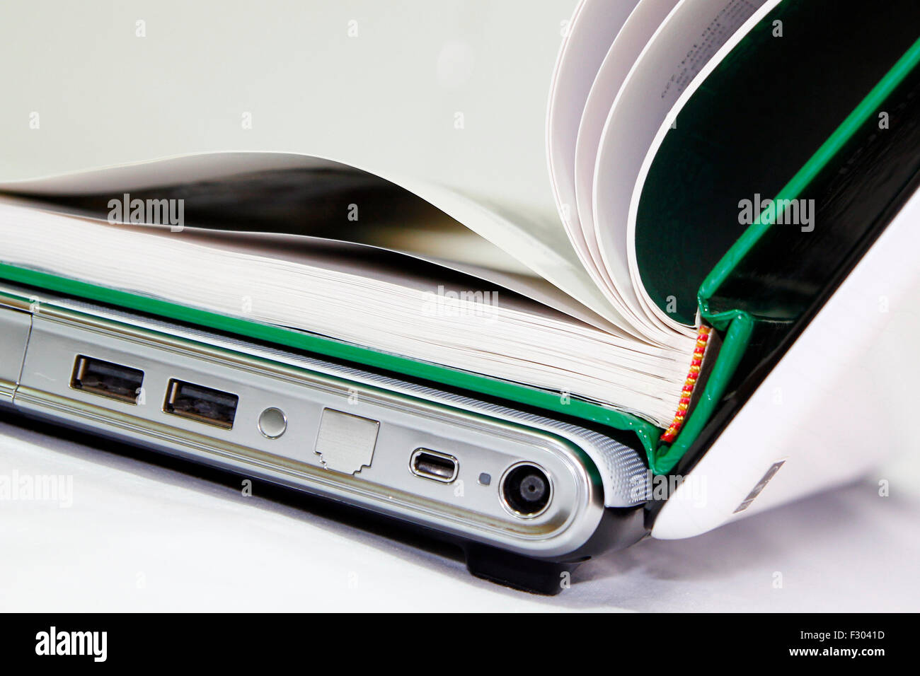 Open book over a laptop Stock Photo - Alamy
