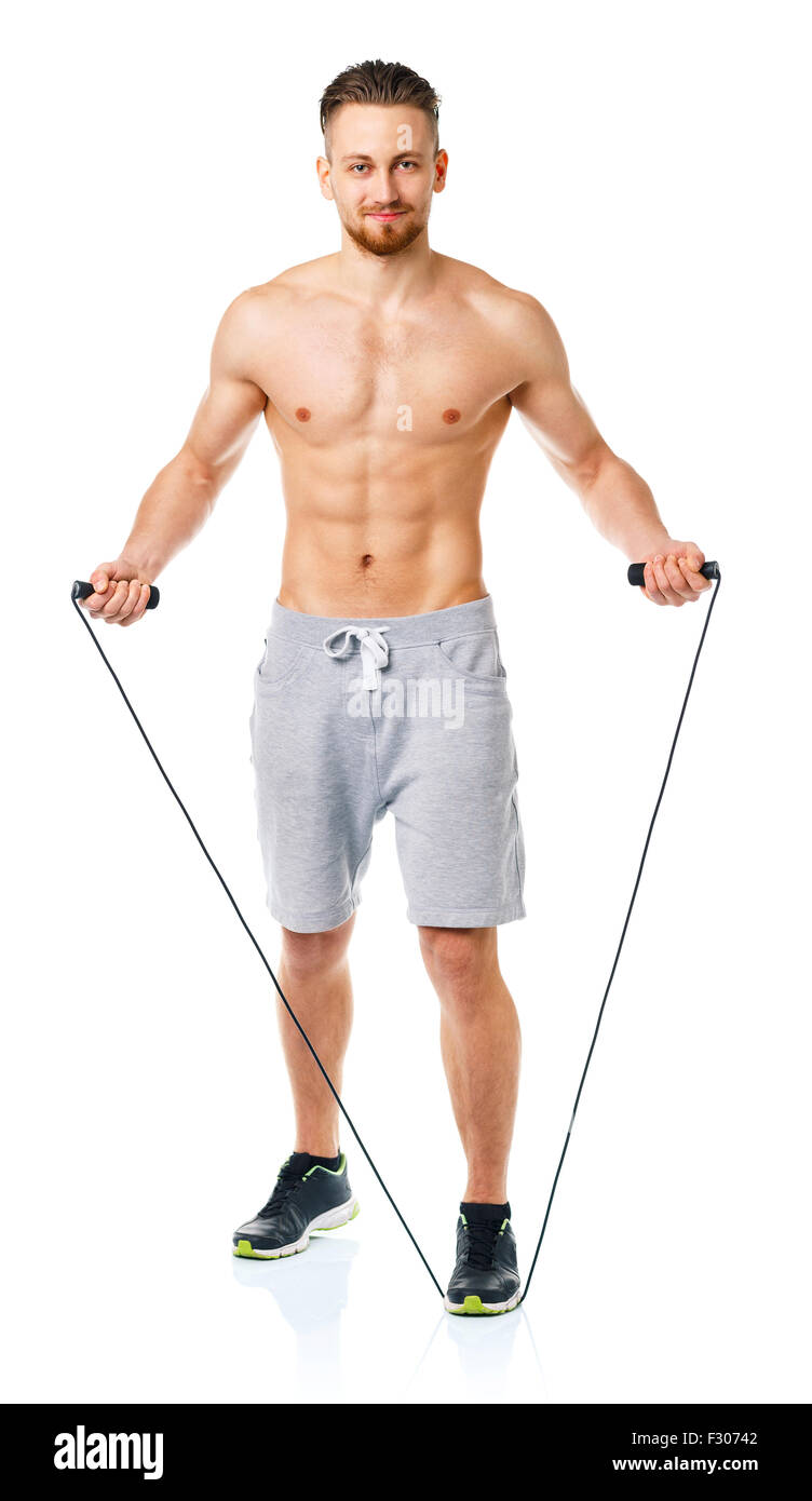 Athletic attractive man jumping on a rope on the white background Stock ...