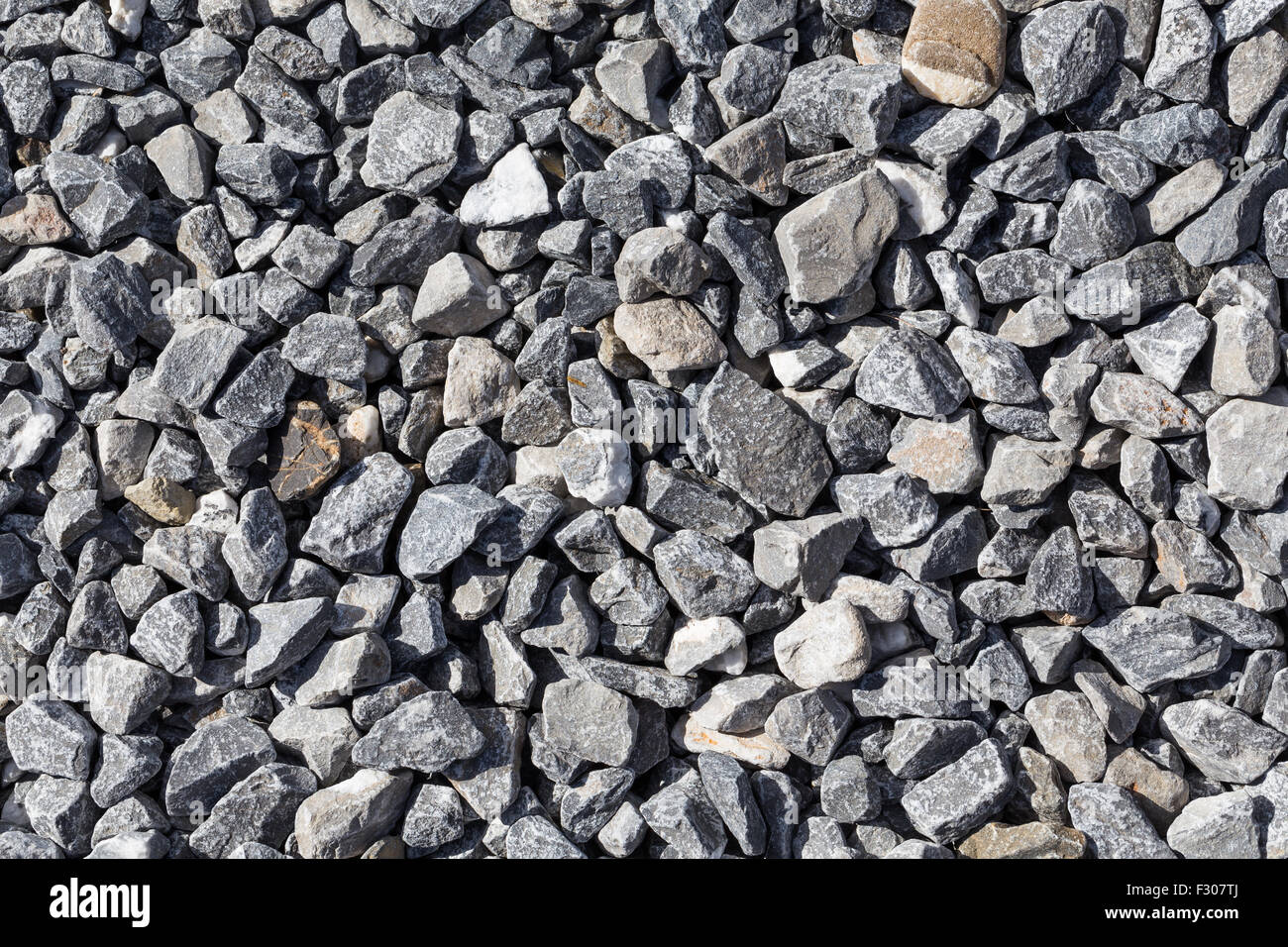 Crushed grey stone on the ground texture background Stock Photo - Alamy