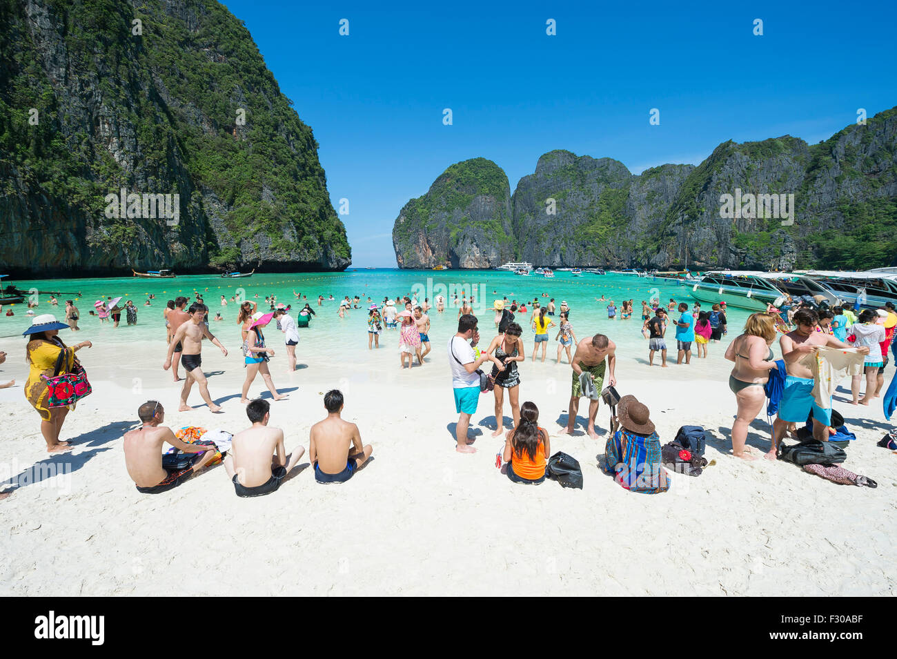 MAYA BAY, THAILAND - NOVEMBER 12, 2014: Crowds of sunbathing visitors ...