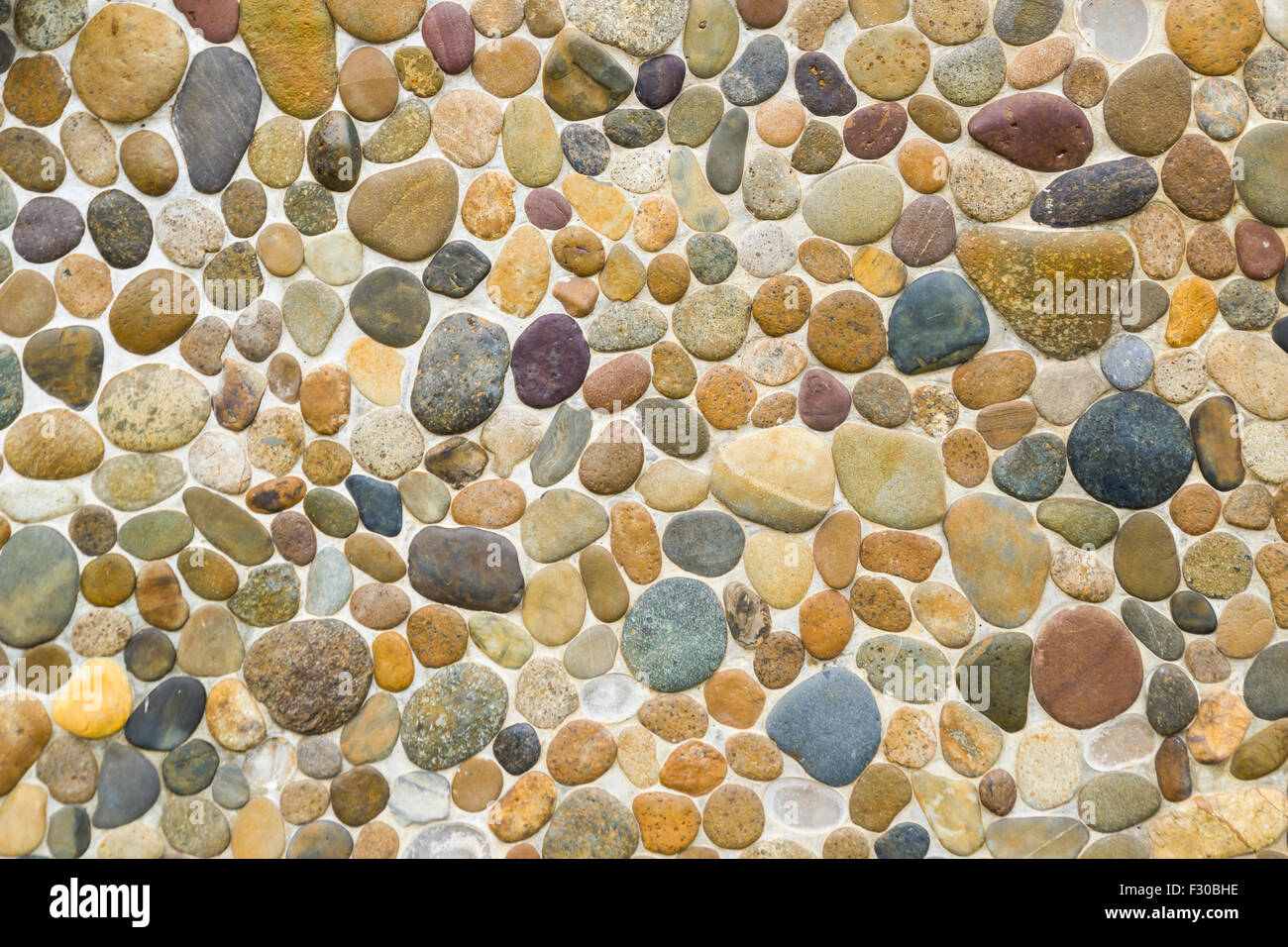 Color boulder on stone wall Stock Photo - Alamy