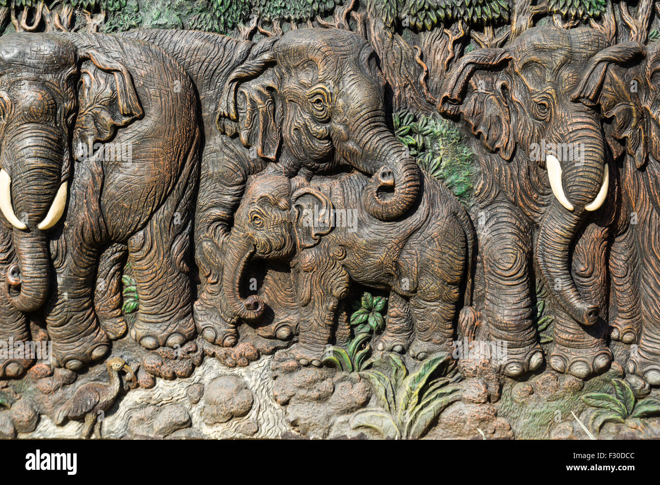 Beautiful elephants carve on wood Stock Photo - Alamy