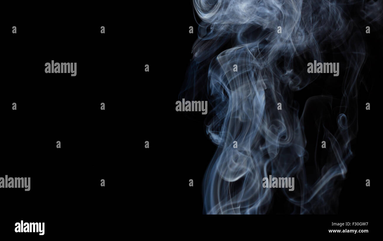 Abstract white floating smoke on dark background Stock Photo - Alamy