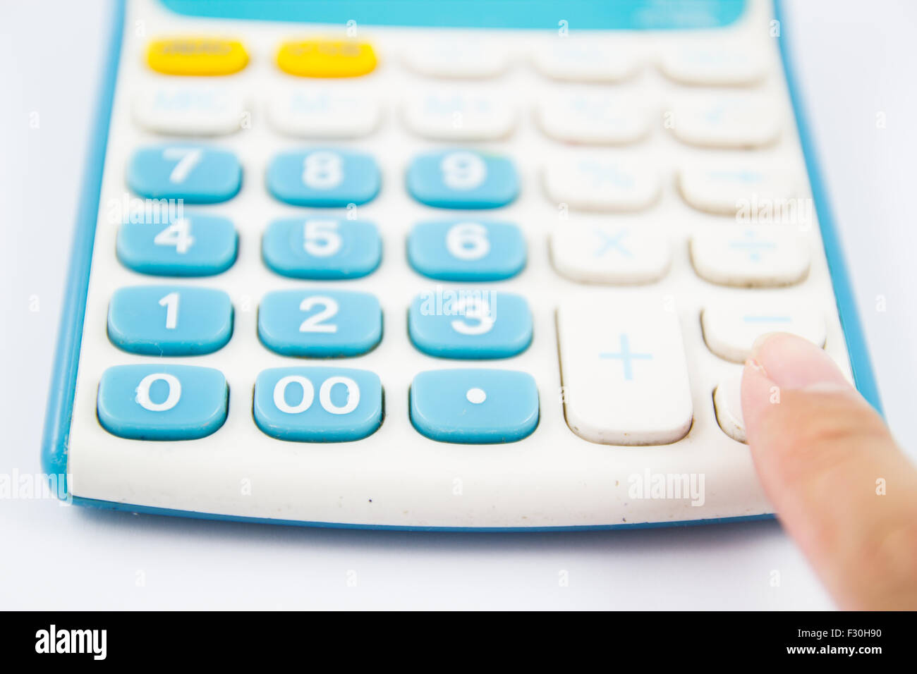 Finger on calculator in white background Stock Photo - Alamy
