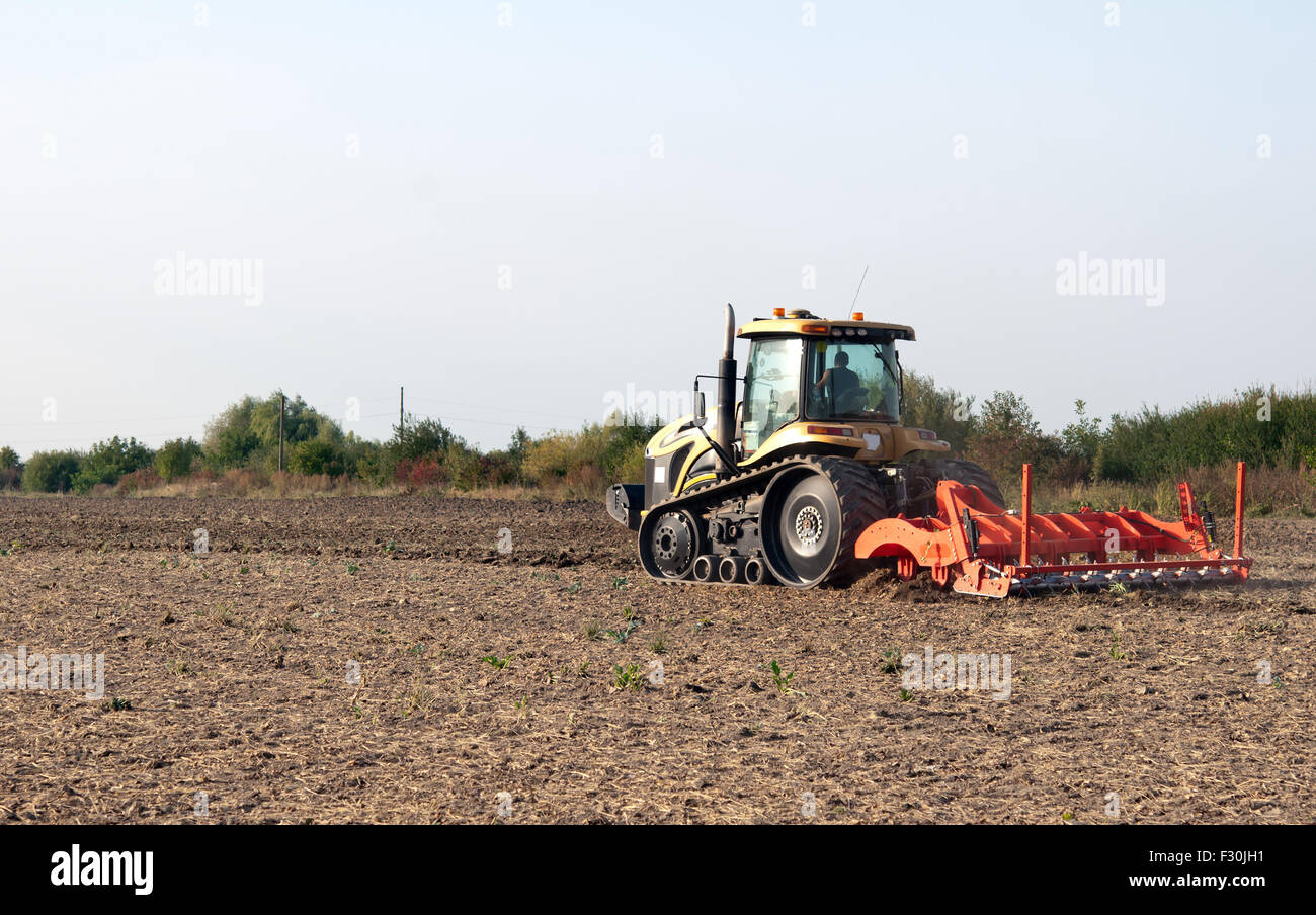 farmer in tractor preparing land with seedbed cultivator Stock Photo ...