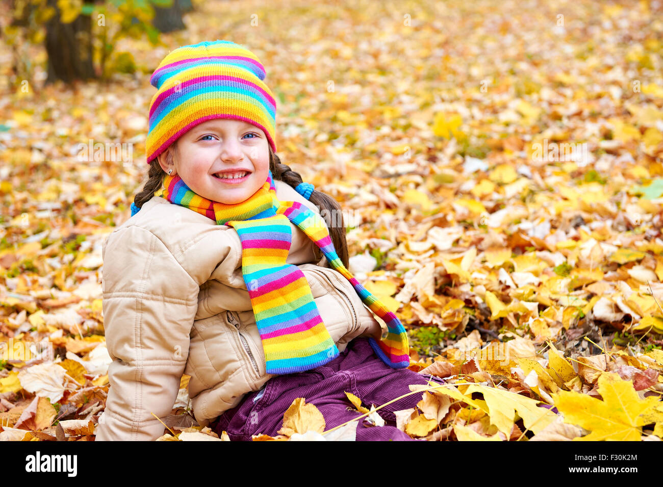 girl on fall autumn leaves in park Stock Photo - Alamy