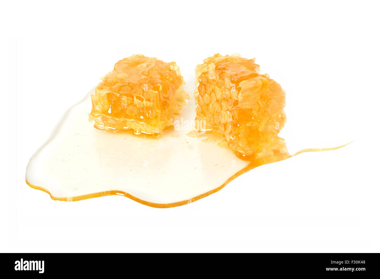 Two honeycomb cubes/ pieces in honey dripping sirup made of fresh greek ...
