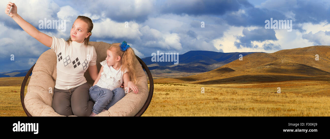Two sisters making selfie on scenery landscape background Stock Photo ...