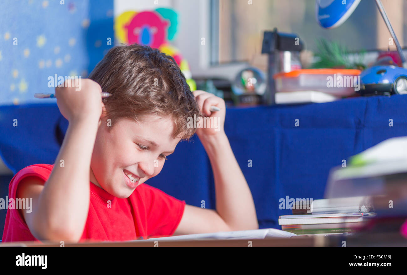 Teenage boy sitting and preparing his homework Stock Photo - Alamy