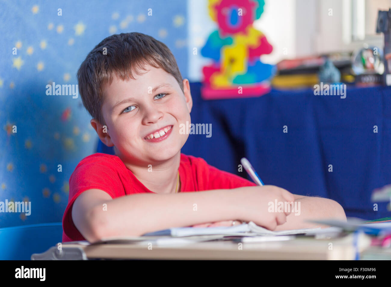 Boy sitting and making school homework home work Stock Photo - Alamy