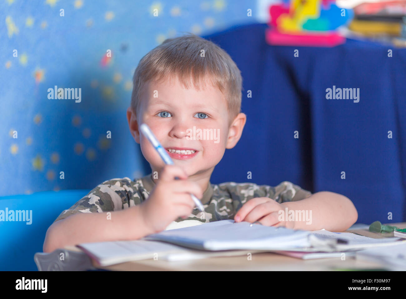 Preschool smiling boy learning to write literacy Stock Photo - Alamy