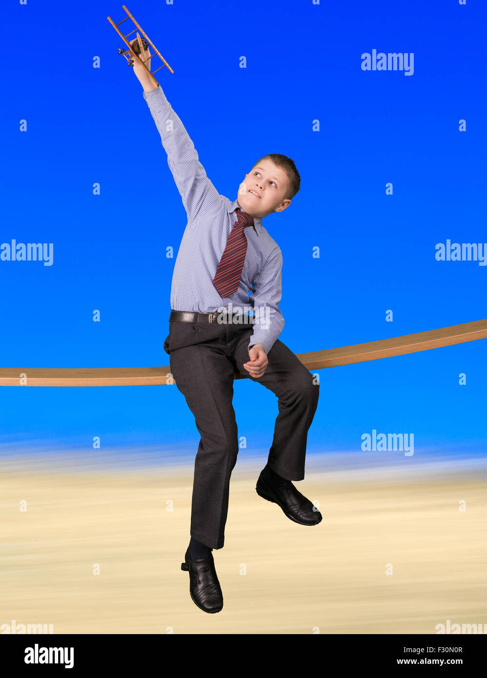 boy in a suit playing with plane model Stock Photo - Alamy