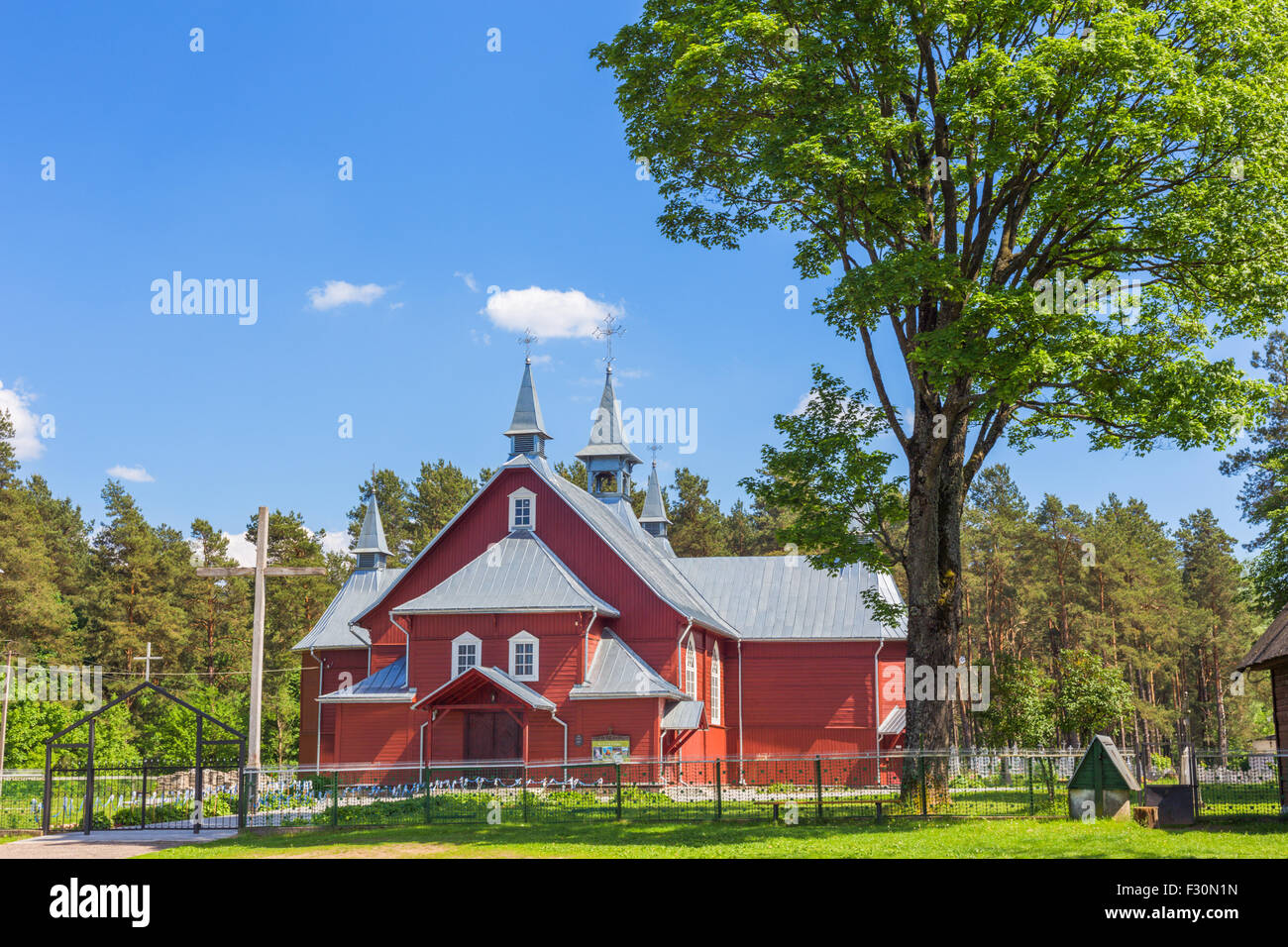 Red wooden church at countryside tree nature Stock Photo - Alamy