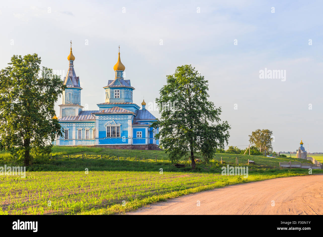 Blue wooden church at countryside tree nature Stock Photo - Alamy