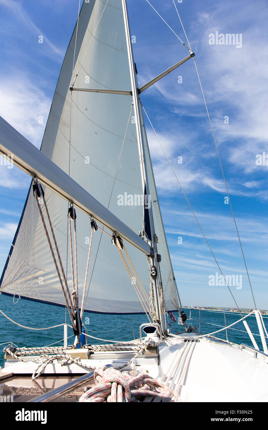 Yatch sail and desk on blue sky and sea background Stock Photo - Alamy