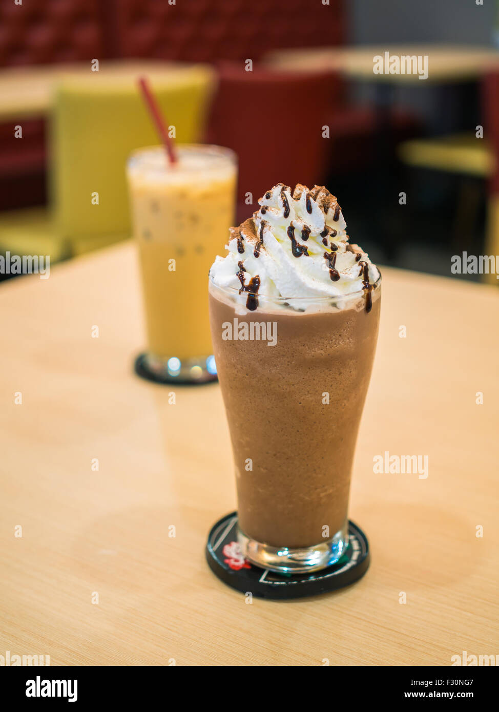 Delicious chocolate frappe with whipped cream on table Stock Photo - Alamy