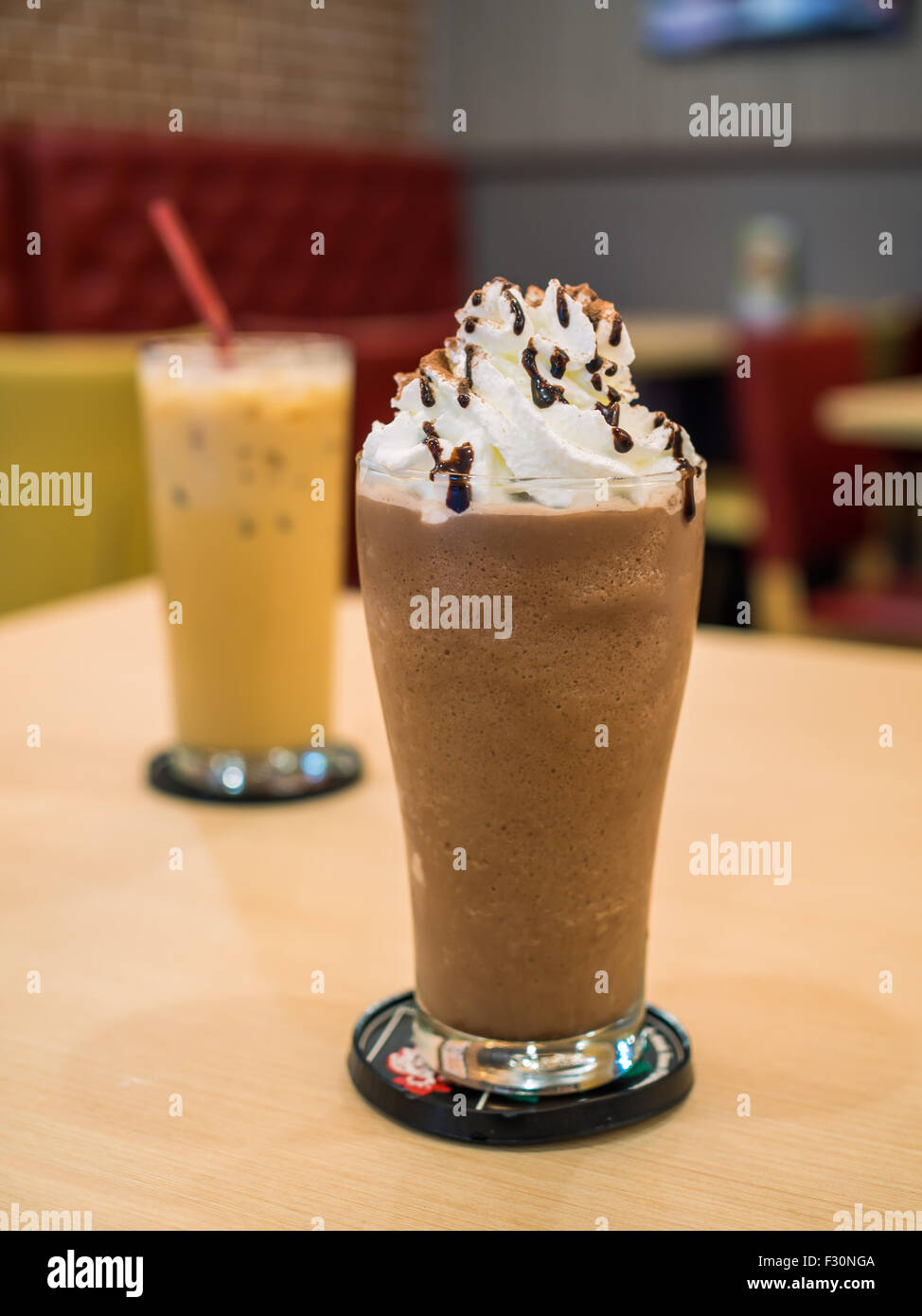 Delicious chocolate frappe with whipped cream on table Stock Photo - Alamy