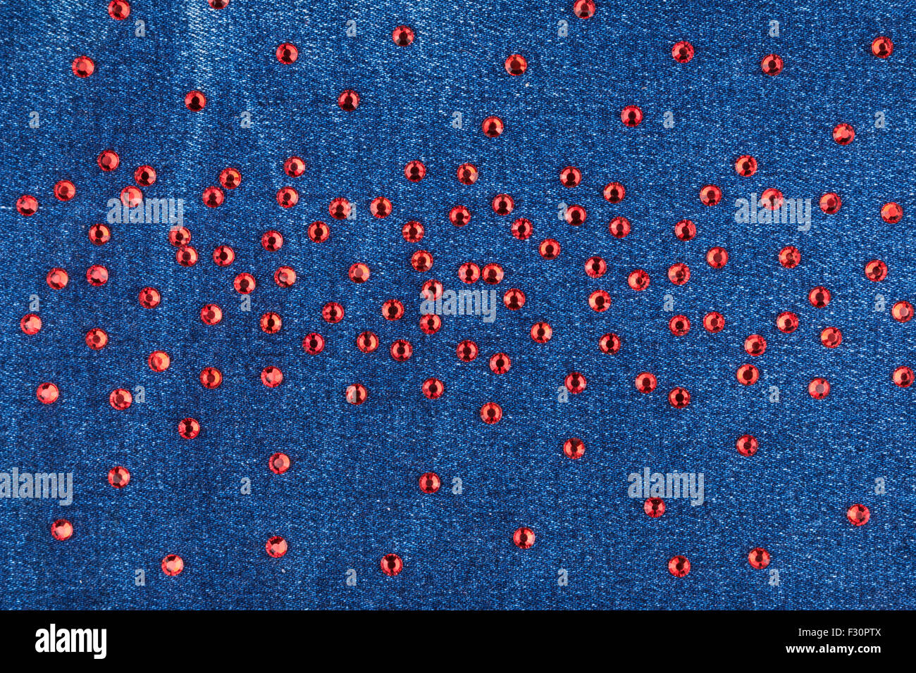Fashionable background, jeans and red rhinestones Stock Photo - Alamy