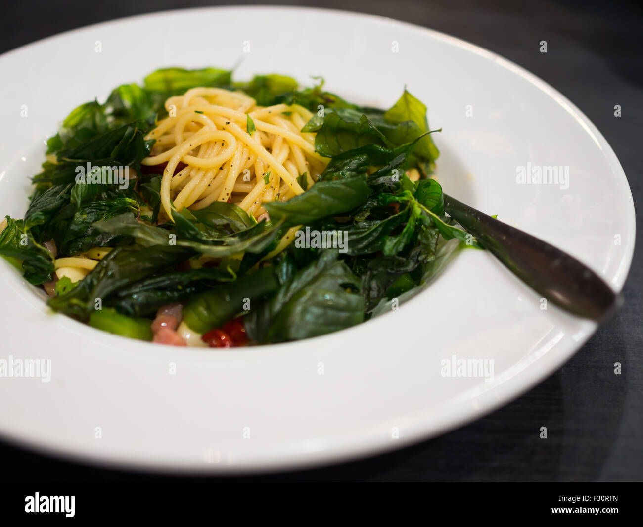 Tasty hot and spicy spaghetti with ham and veggie mix Stock Photo - Alamy