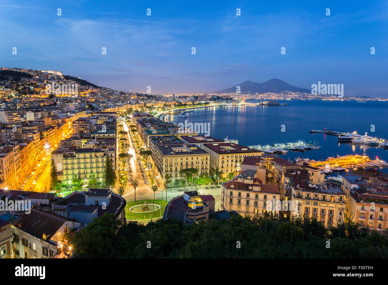 Naples, panoramic view of the city with city lights on and the gulf ...