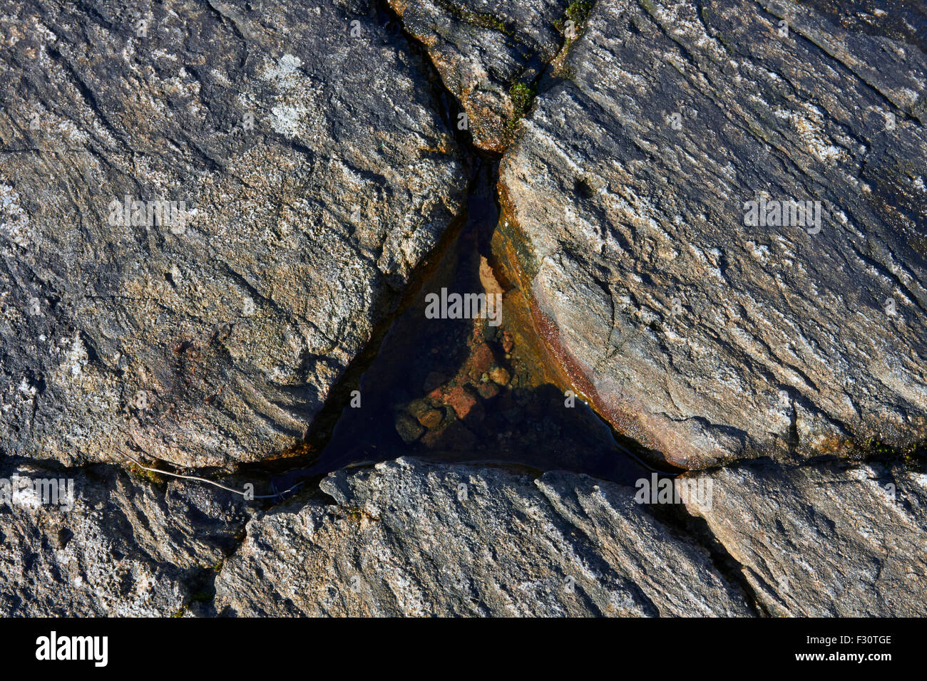 cracks forming triangle on bedrock Stock Photo - Alamy
