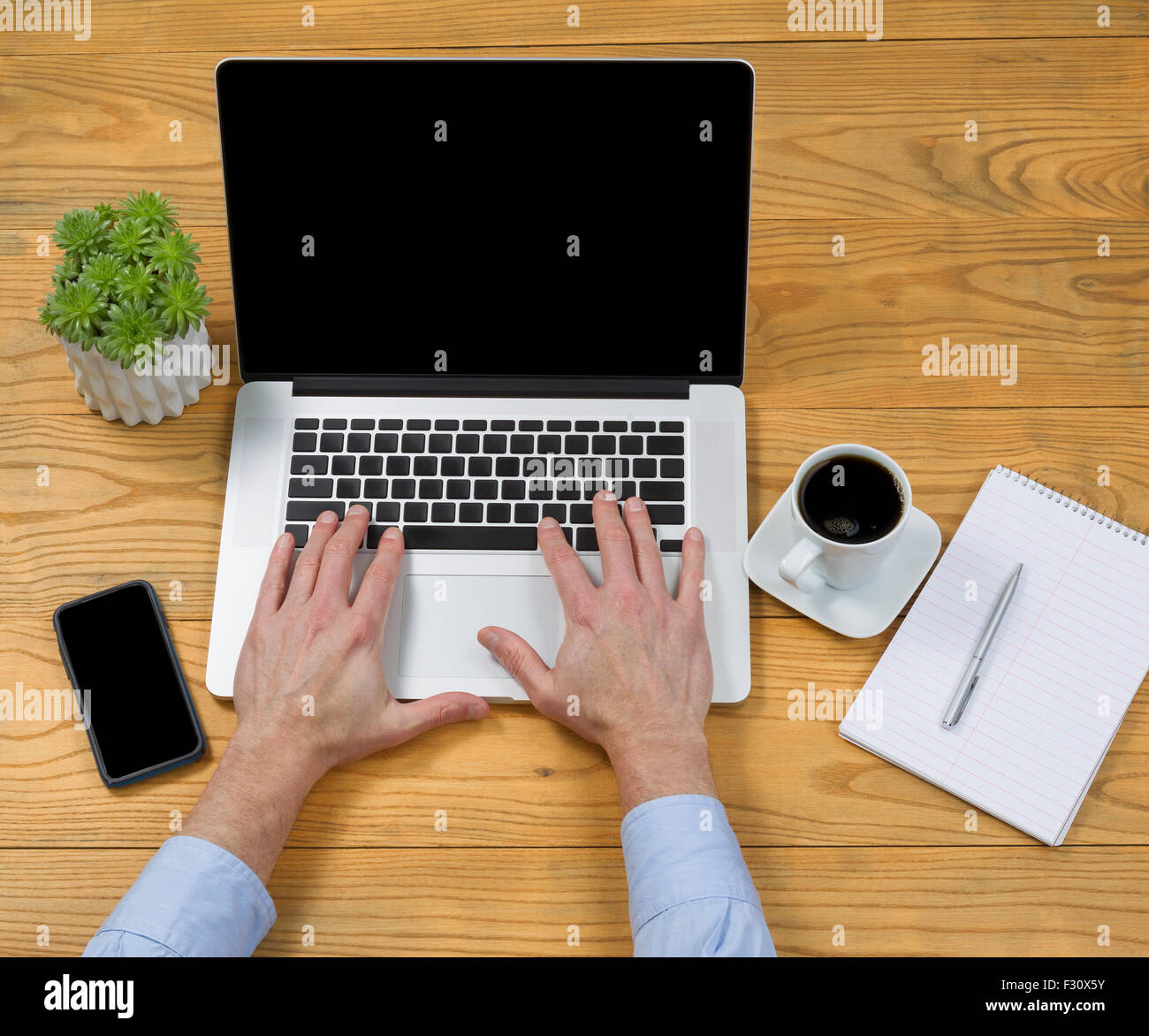 High angled view of male hands typing on computer keyboard on desktop ...