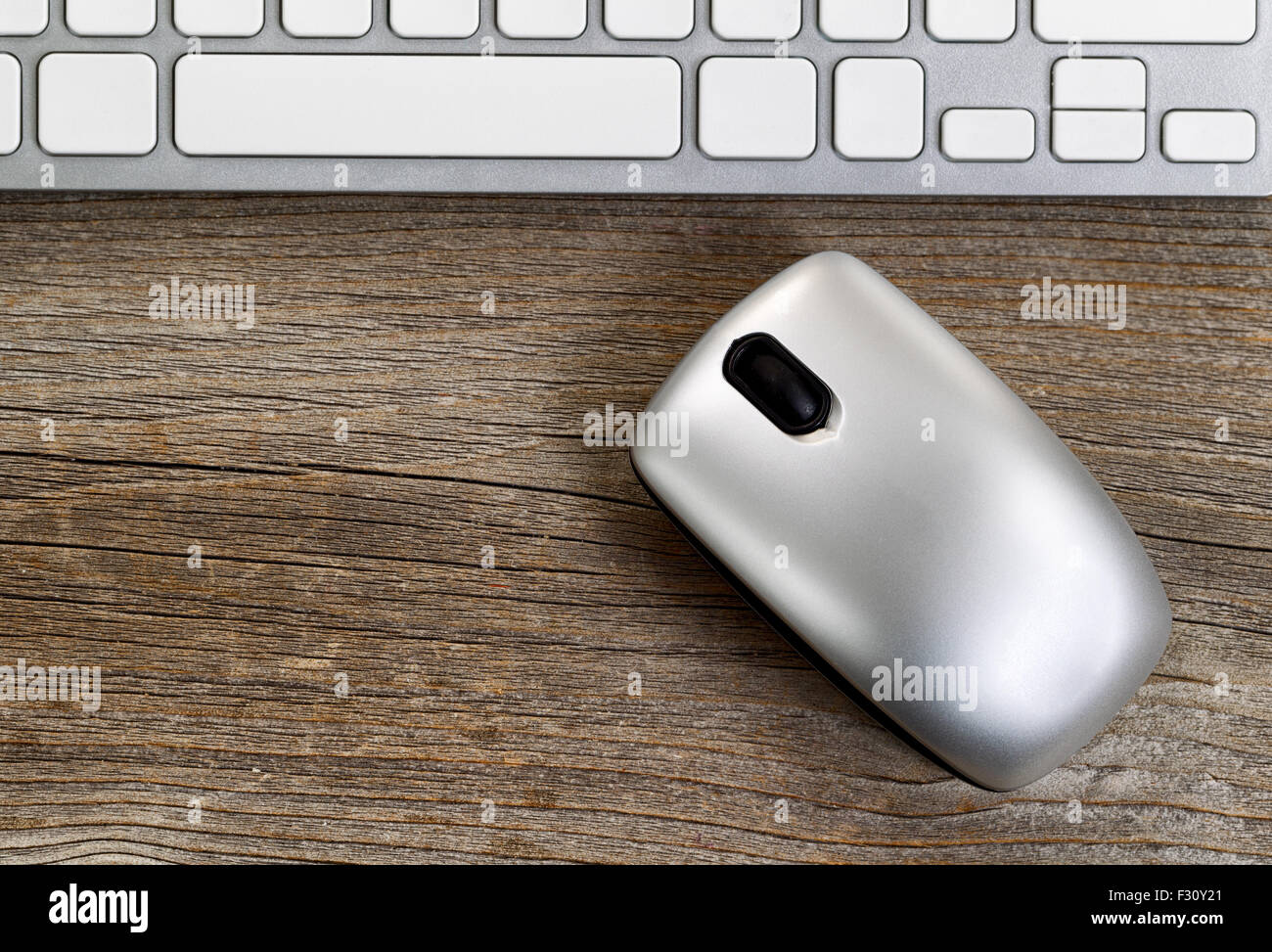 Selective focus on wireless computer mouse with partial keyboard in ...