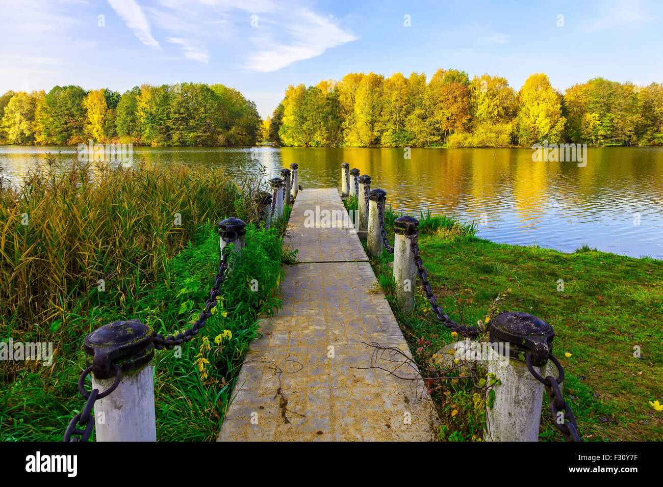 Landscape of Dock and Autumn Shoreline with Colourful Trees of Lake in ...