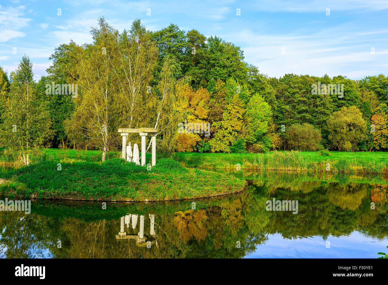 Autumn Landscape with Colourful Trees and Statues of a Man and a Woman ...