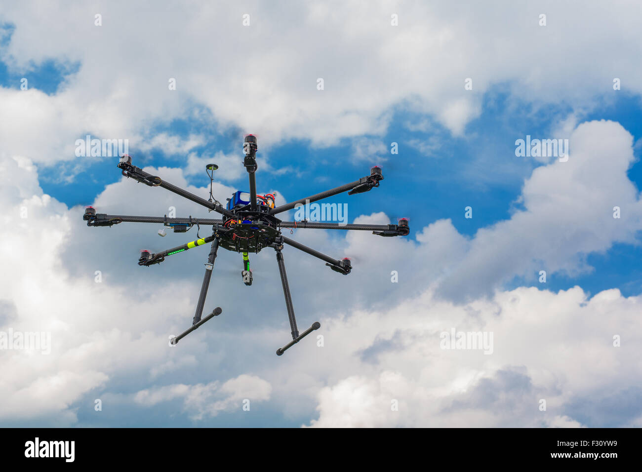 Multicopter in flight on sky and clouds background Stock Photo - Alamy