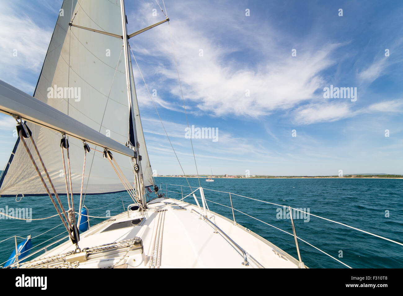 Yatch sail and desk on blue sky and sea background Stock Photo - Alamy