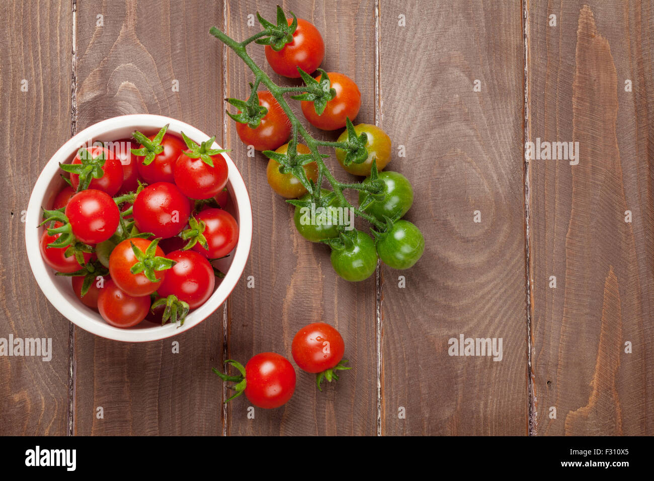 Cherry tomatoes bowl on wooden table. Top view with copy space Stock ...