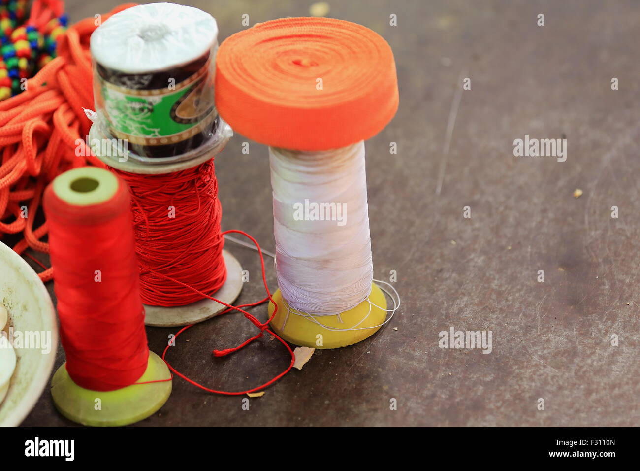 Thread spools for sale in a stall of the street market around ...