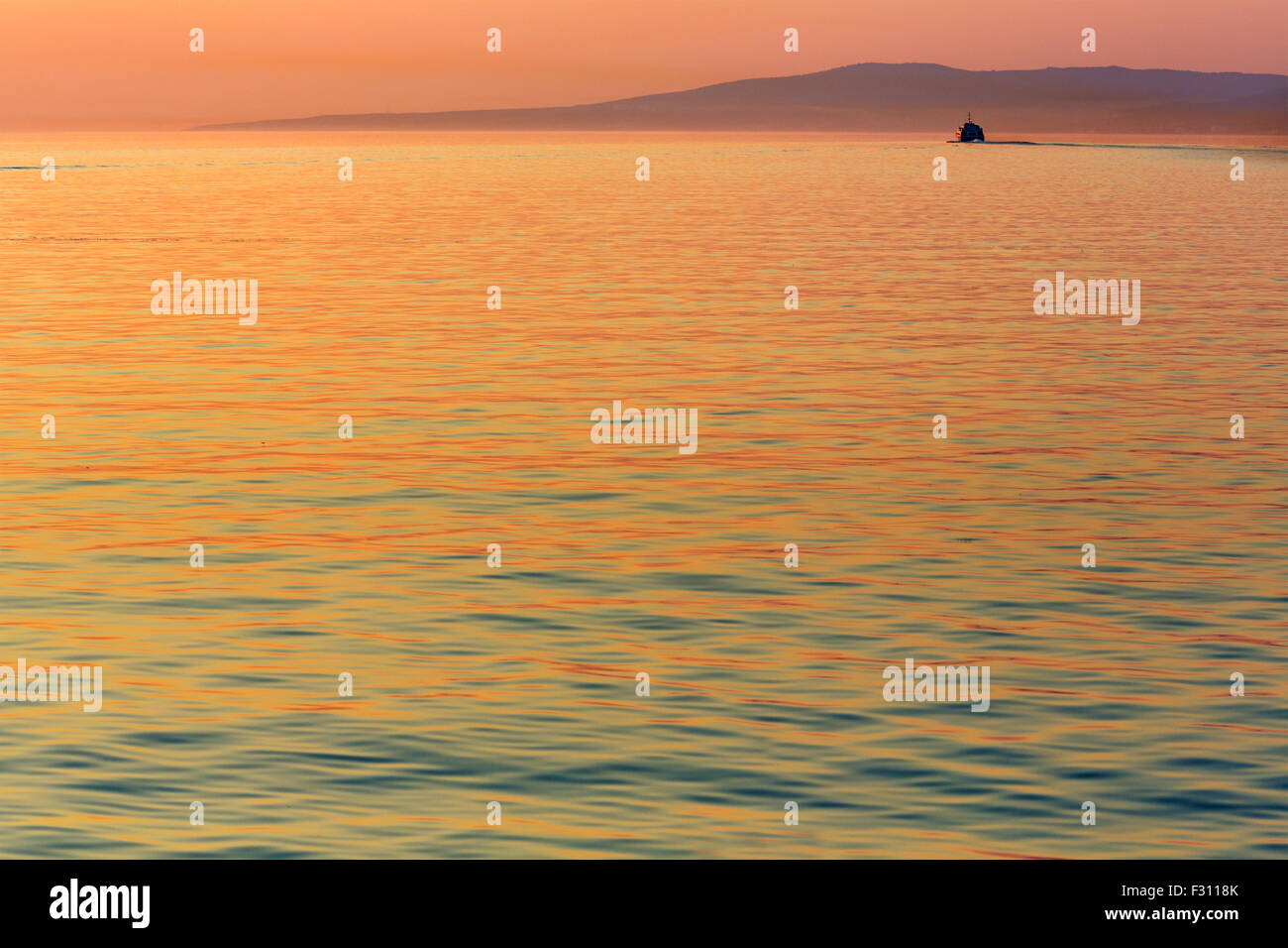 Beautiful seascape with ship at far distance and seashore mountains ...