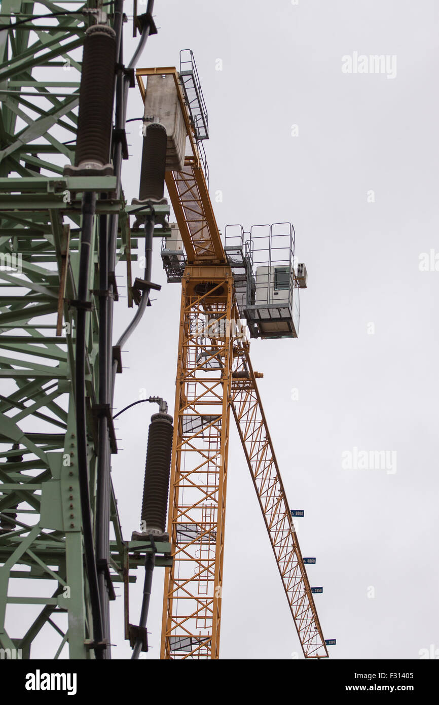 Construction of electric transmission line with yellow crane Stock ...