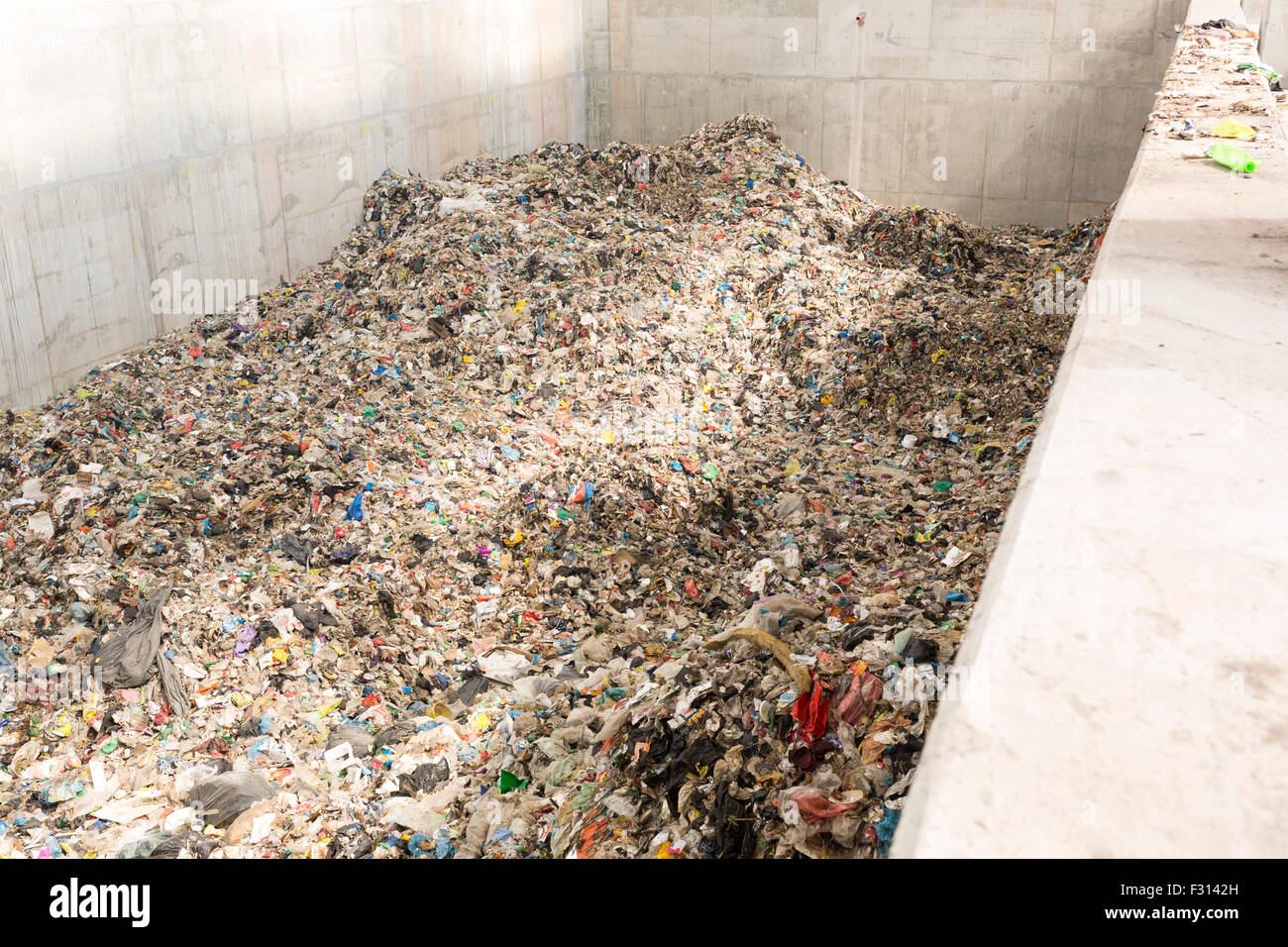 Inside of a new modern waste plant. Pile of waste rwady to be processed ...
