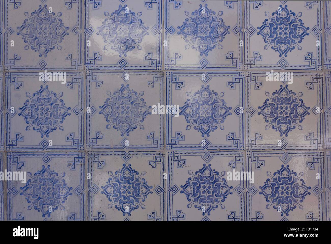Traditional portuguese blue azulejos on a wall. Composition close up ...