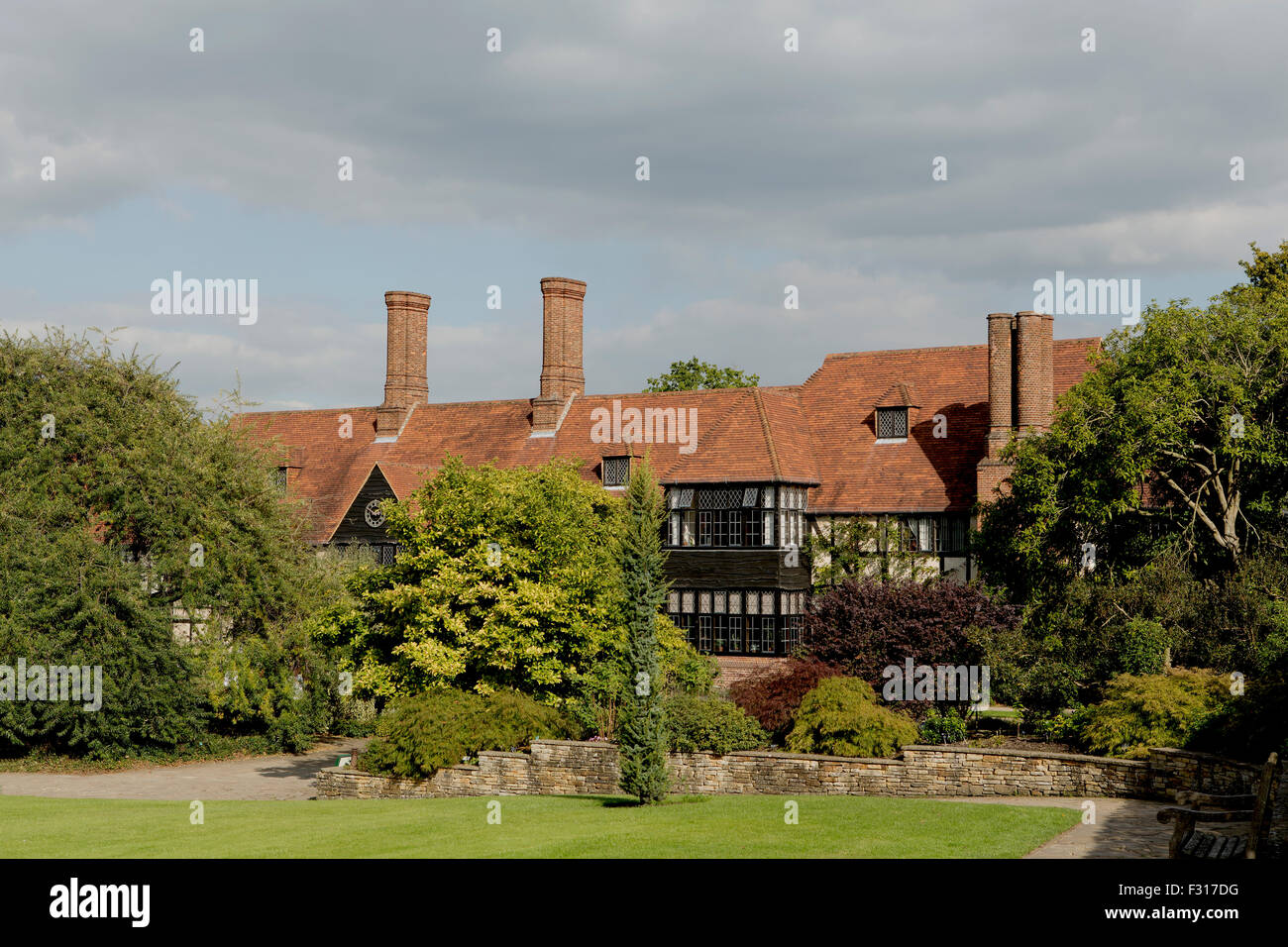 Old country house as a backdrop to a formal garden Stock Photo - Alamy