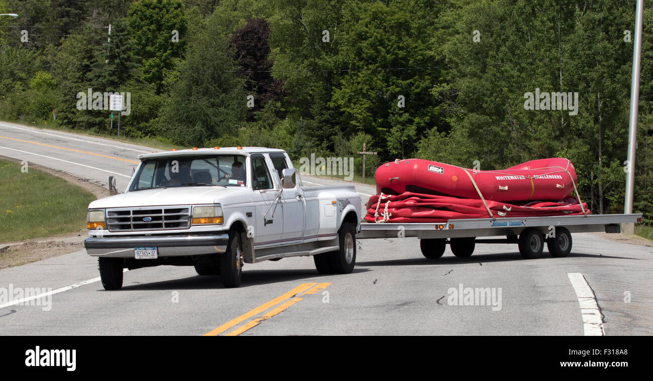 Whitewater white water rafts towed on a trailer behind a pickup truck ...