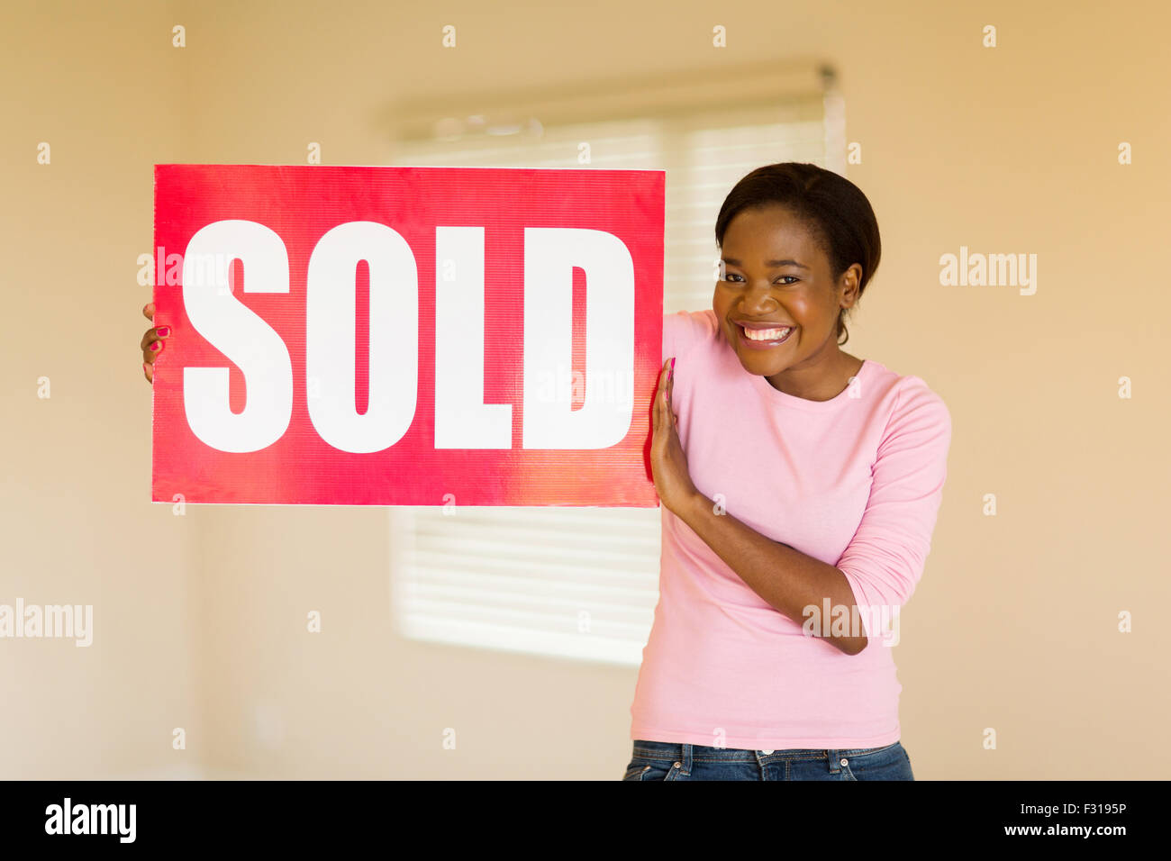 Woman holding sold sign hi-res stock photography and images - Alamy