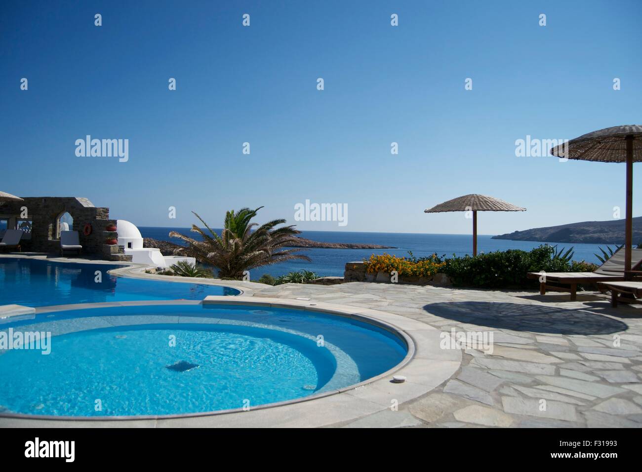 Beach facing swimming pool resort relax sea blue Stock Photo - Alamy