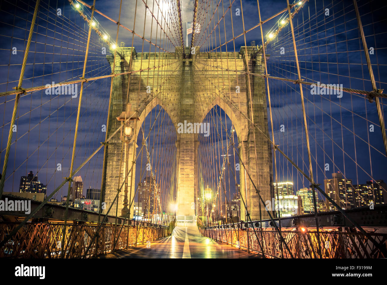 View of historic Brooklyn Bridge at night seen from the pedestrian ...