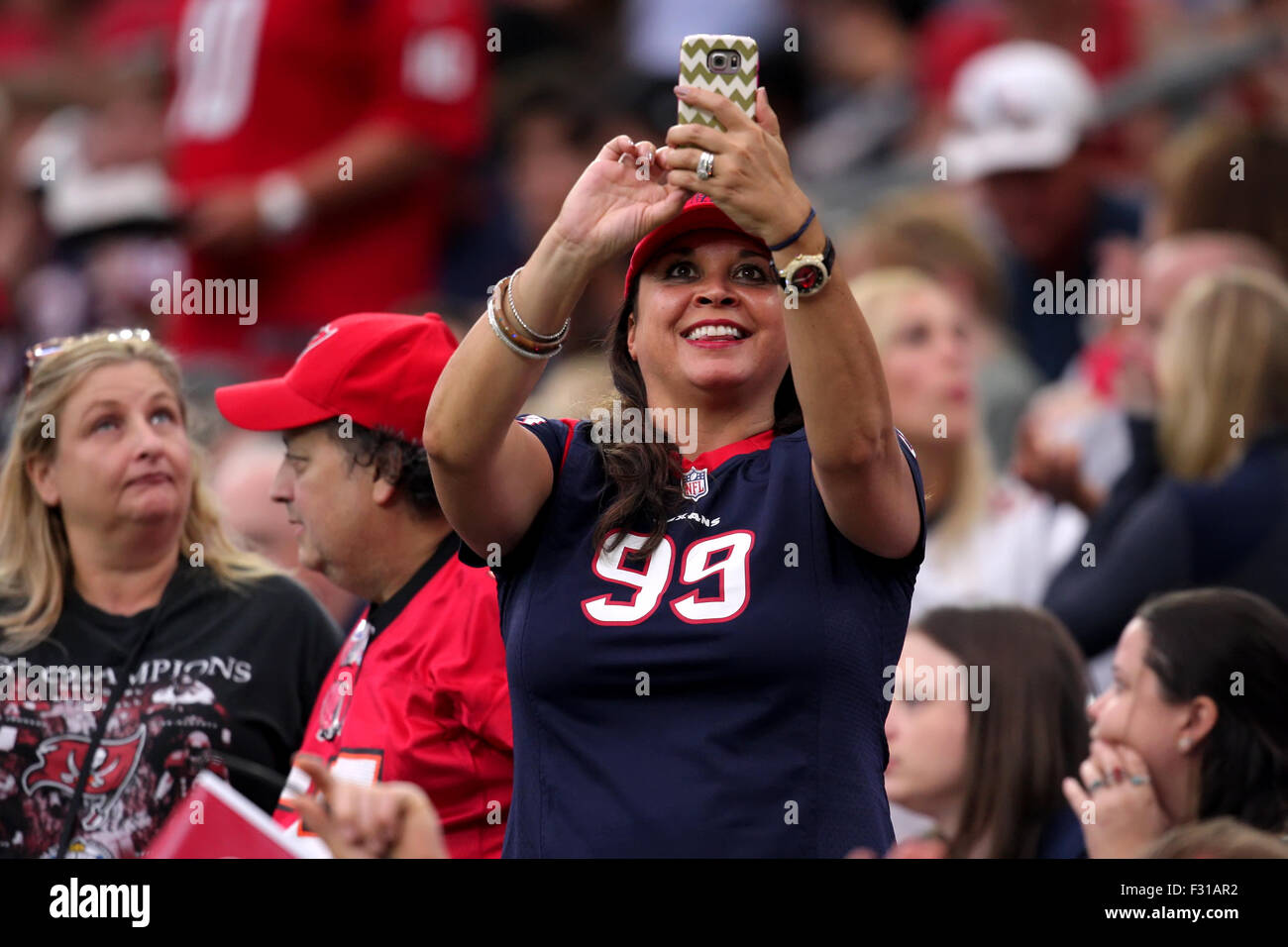 SEP 27 2015: A Houston Texans fan takes photos of the action on the ...