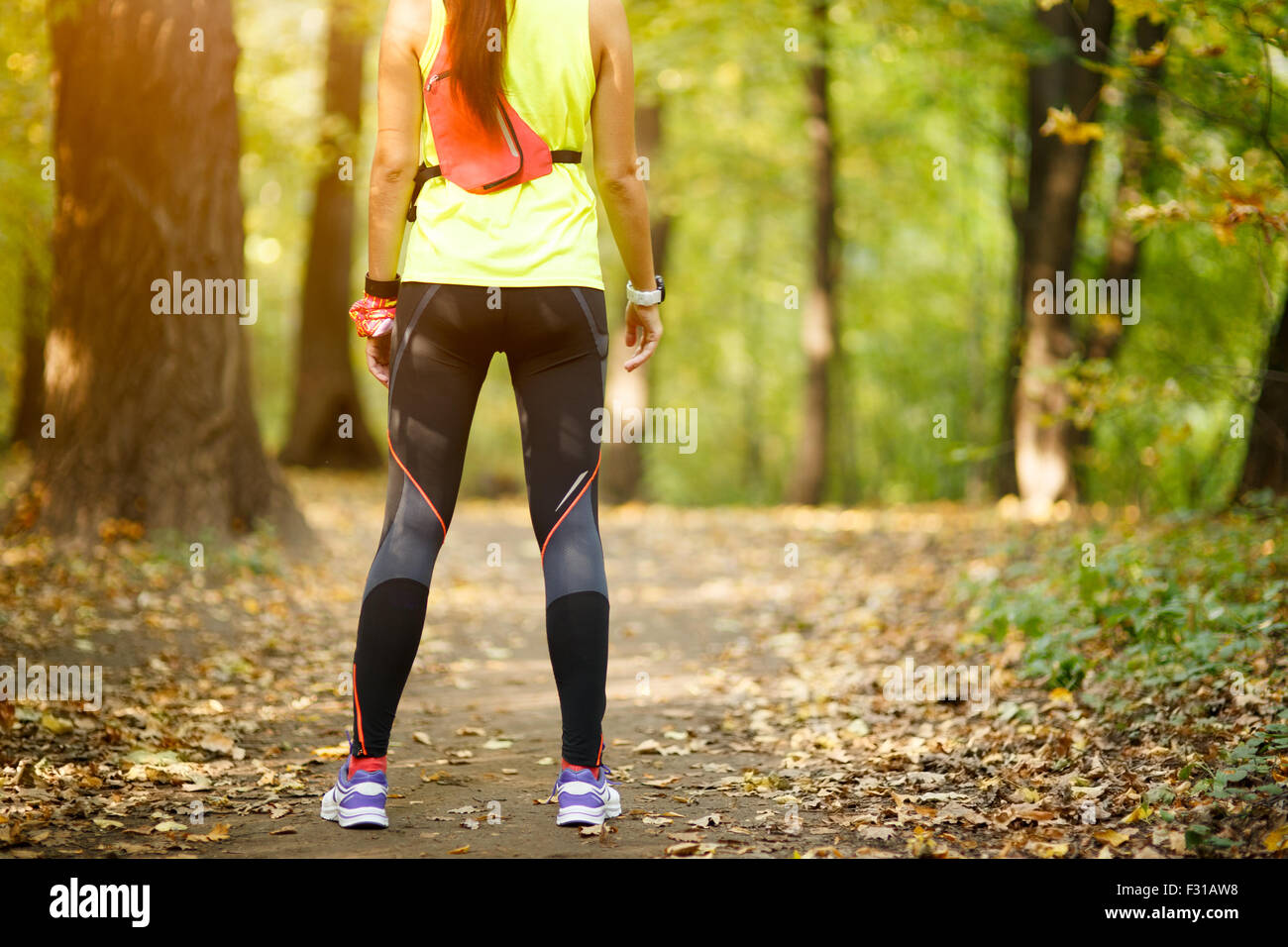 young fit woman doing exercise in park, rear view Stock Photo - Alamy