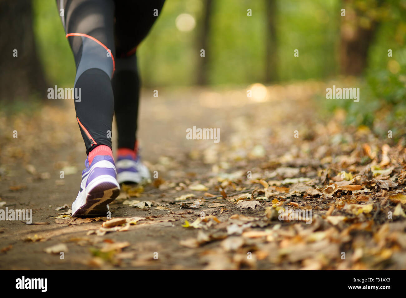 Runner feet running on road closeup on shoes in park Stock Photo - Alamy
