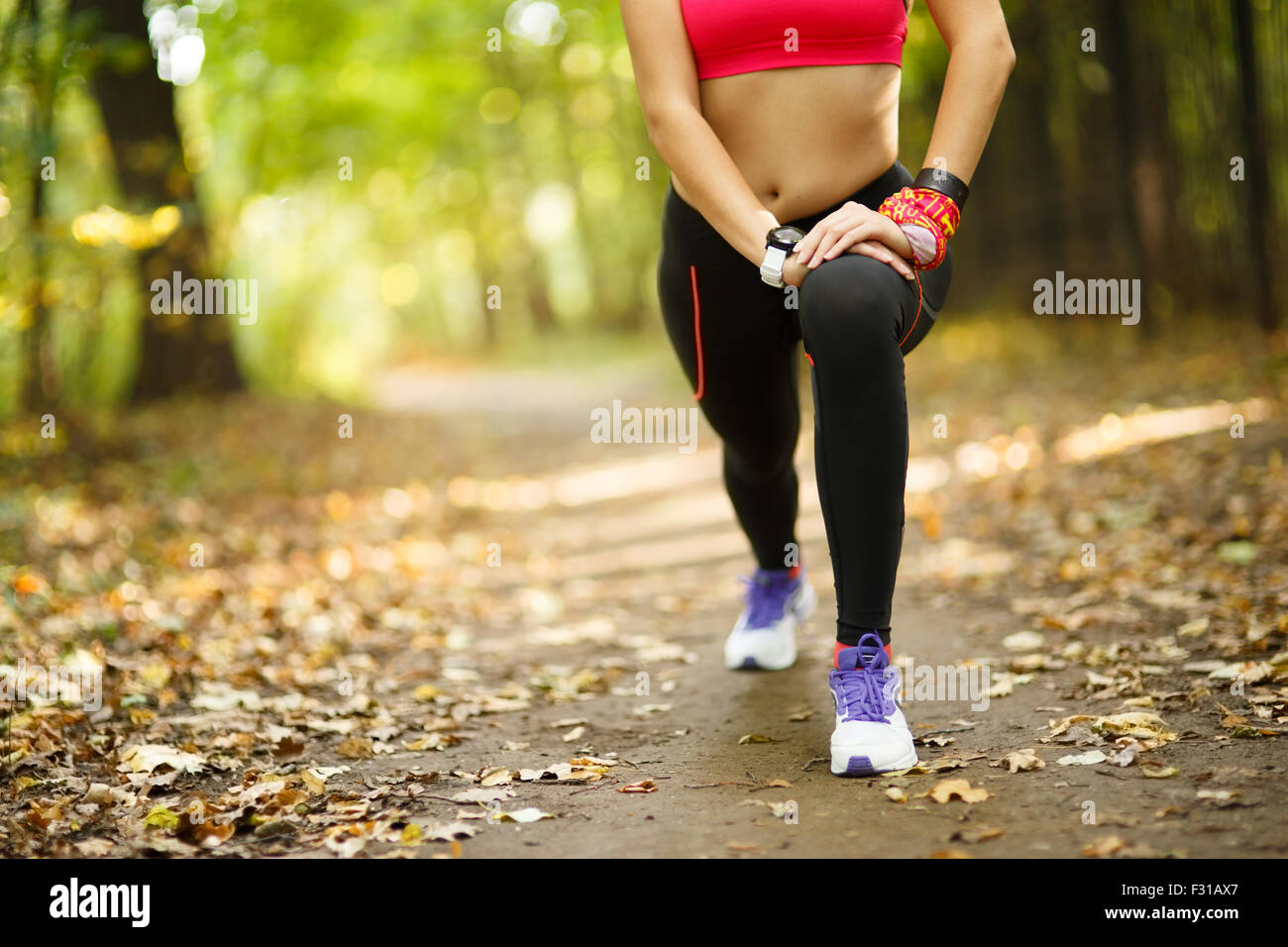 woman exercising and stretching muscles before sport activity in park ...