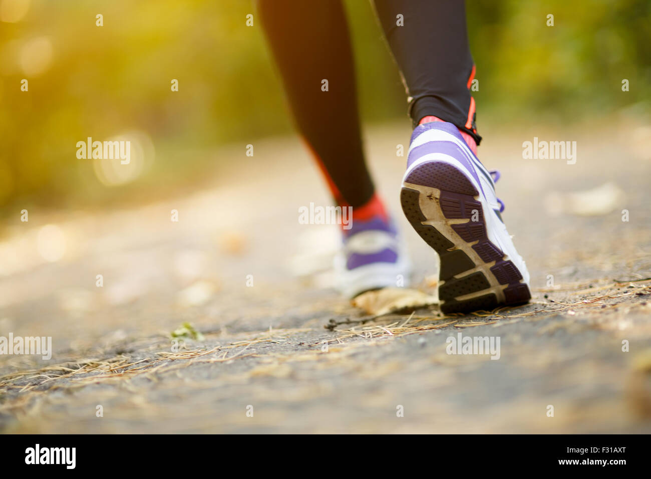 Runner feet running on road closeup on shoes in park Stock Photo - Alamy