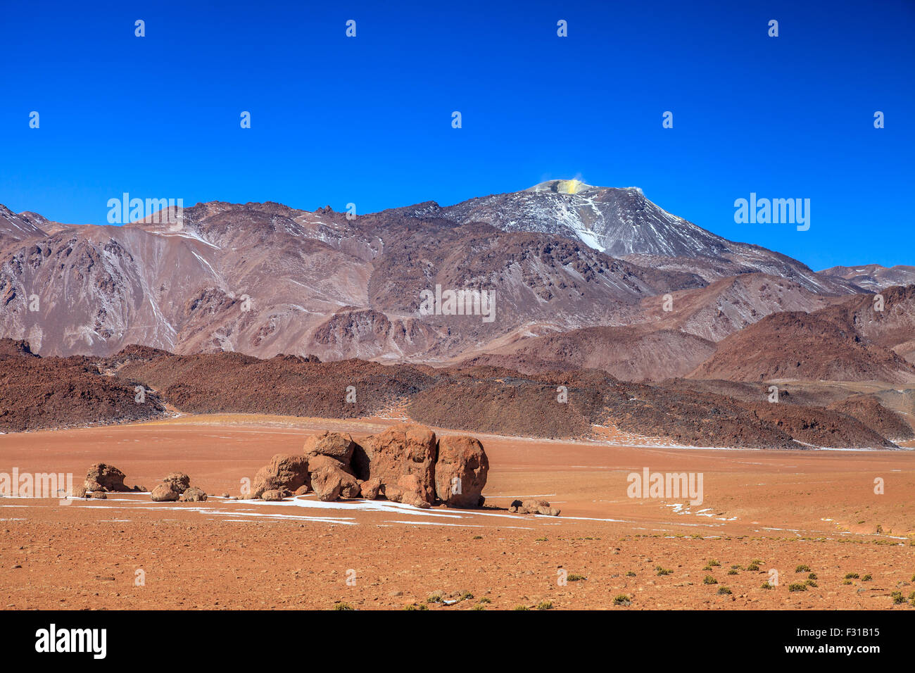 Cerro Volcano Colorado with rocks formation in the foreground (Atacama ...