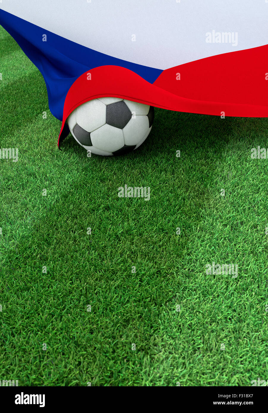 Soccer ball and national flag of Czech Republic lies on the green grass ...